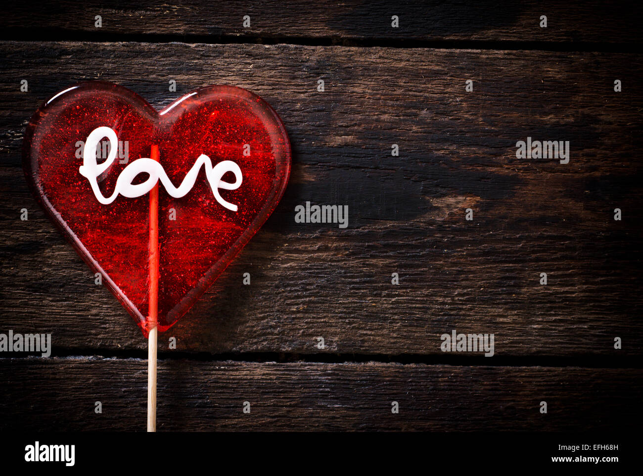 Heart shape lolly pop on the wooden background with empty space Stock ...