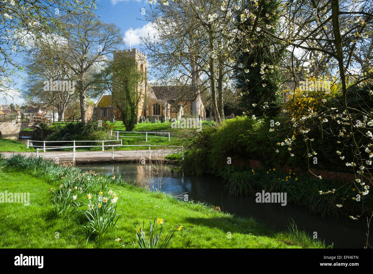 St Giles' church from beside Medbourne Brook in spring in the pretty ...