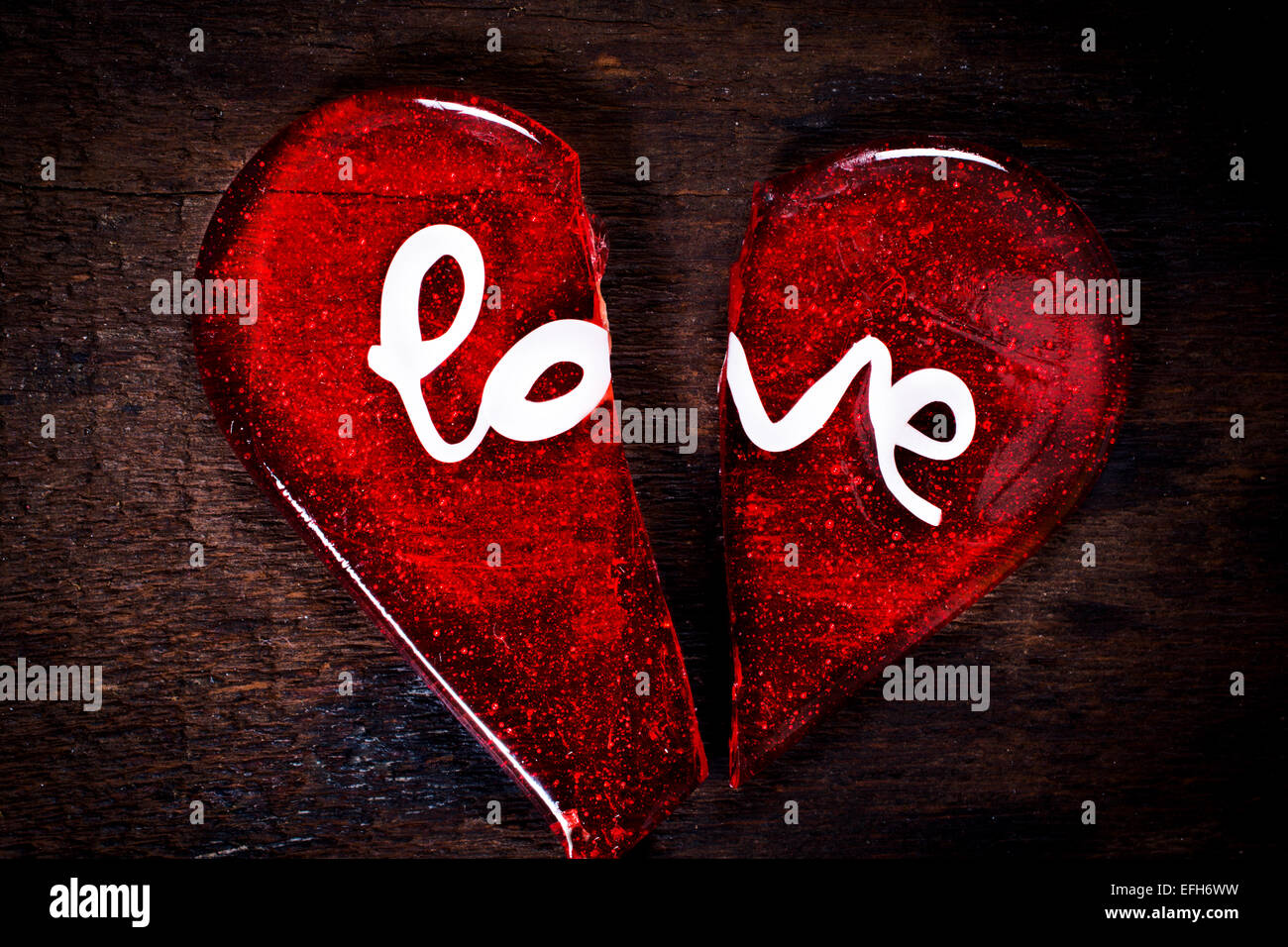 Broken heart with love sign on wooden bacground Stock Photo - Alamy