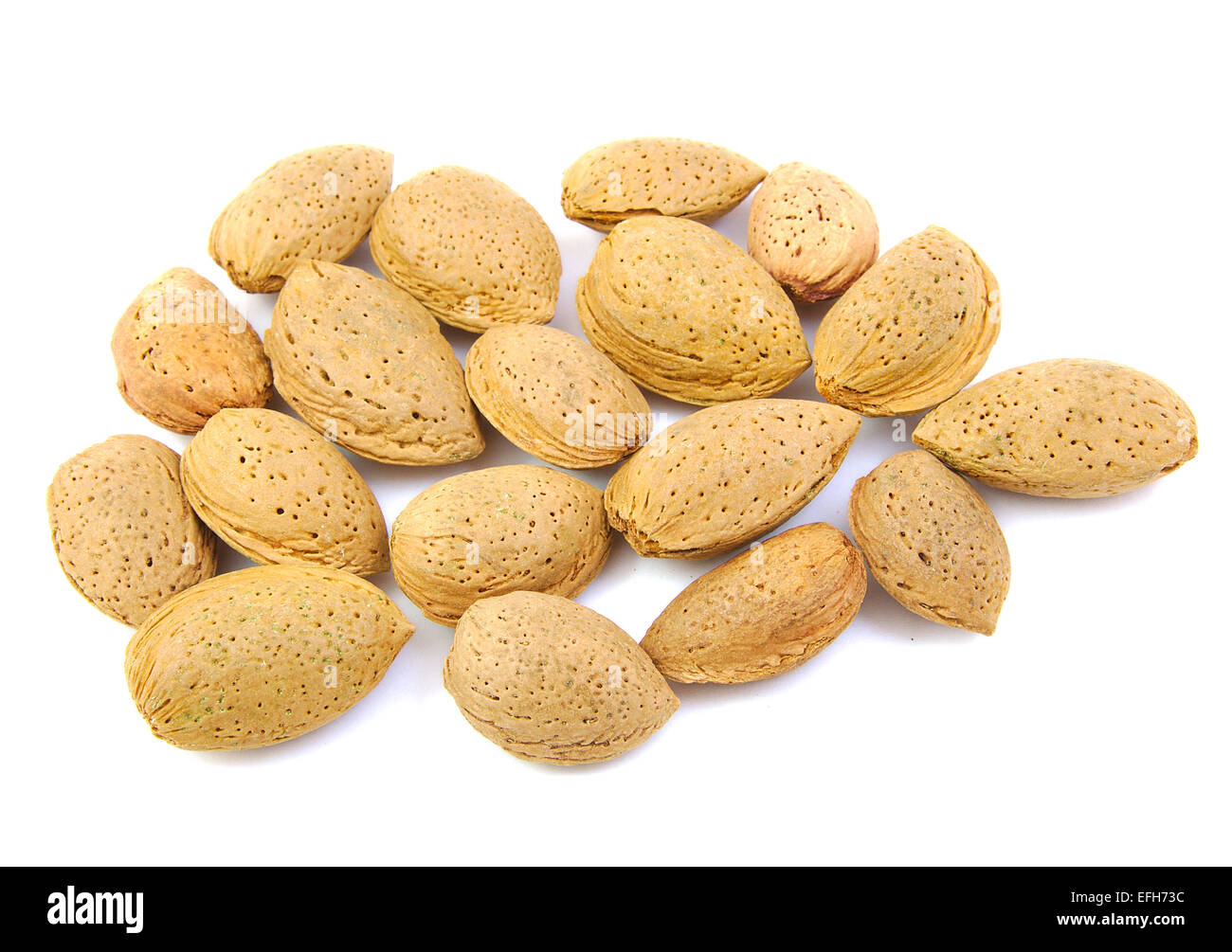 Almonds in shell on a white background Stock Photo - Alamy