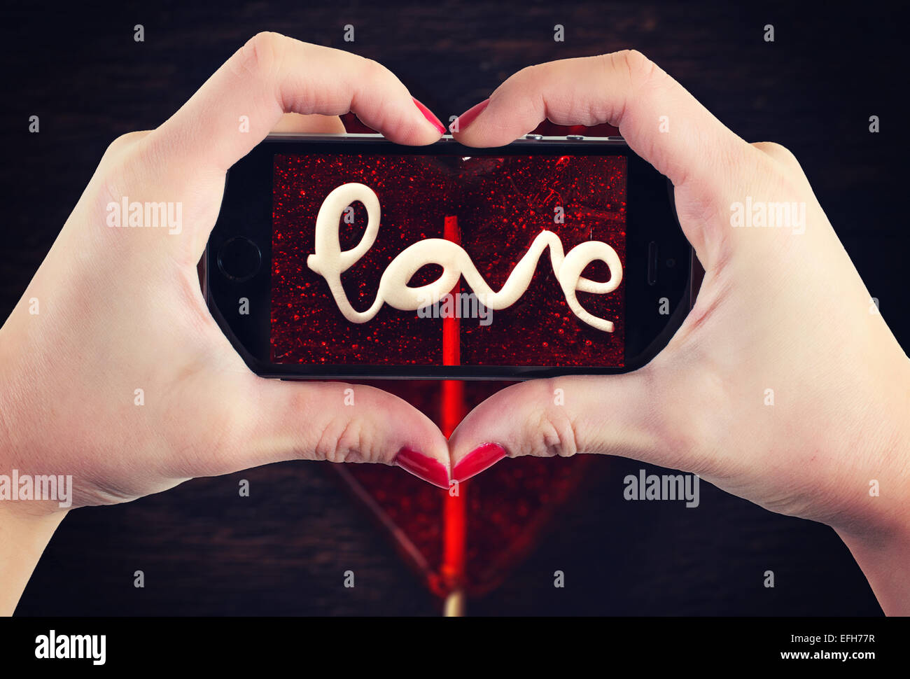 Female photographing love sign with her camera Stock Photo - Alamy