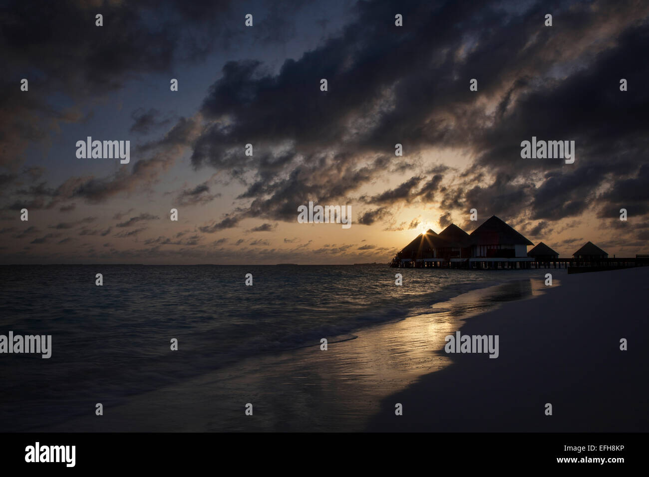 Sunrise over a beach on an Island in The Maldives Stock Photo - Alamy