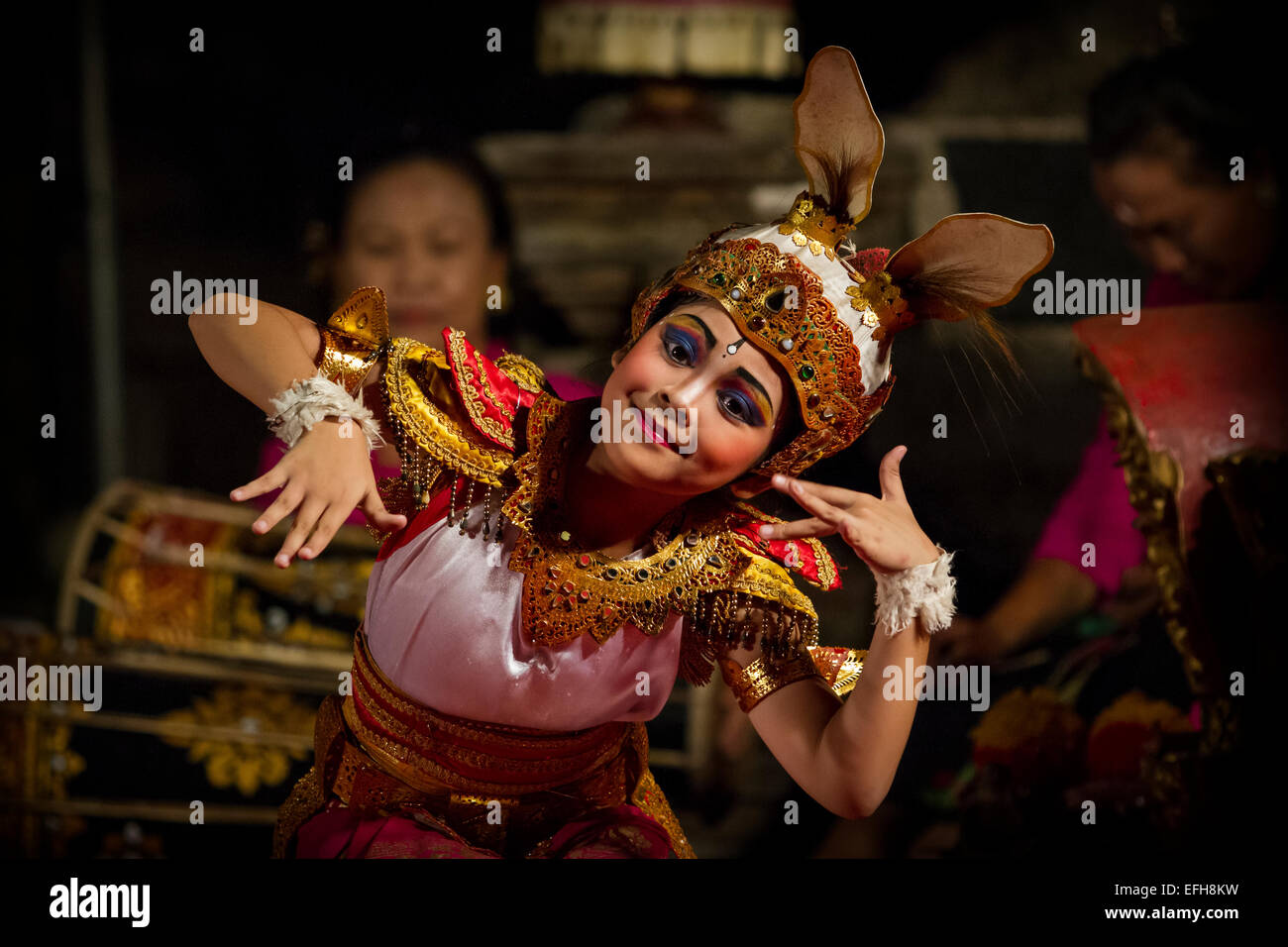 Young girl performing a traditional Balinese dance on stage in Ubud ...