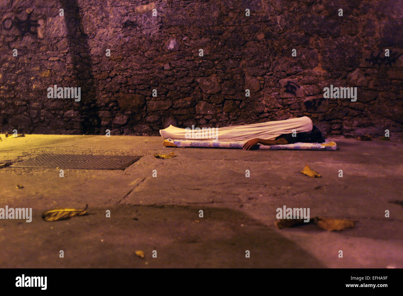 RIO DE JANEIRO, BRAZIL-JULY 6: A homeless man sleeps on a side street ...