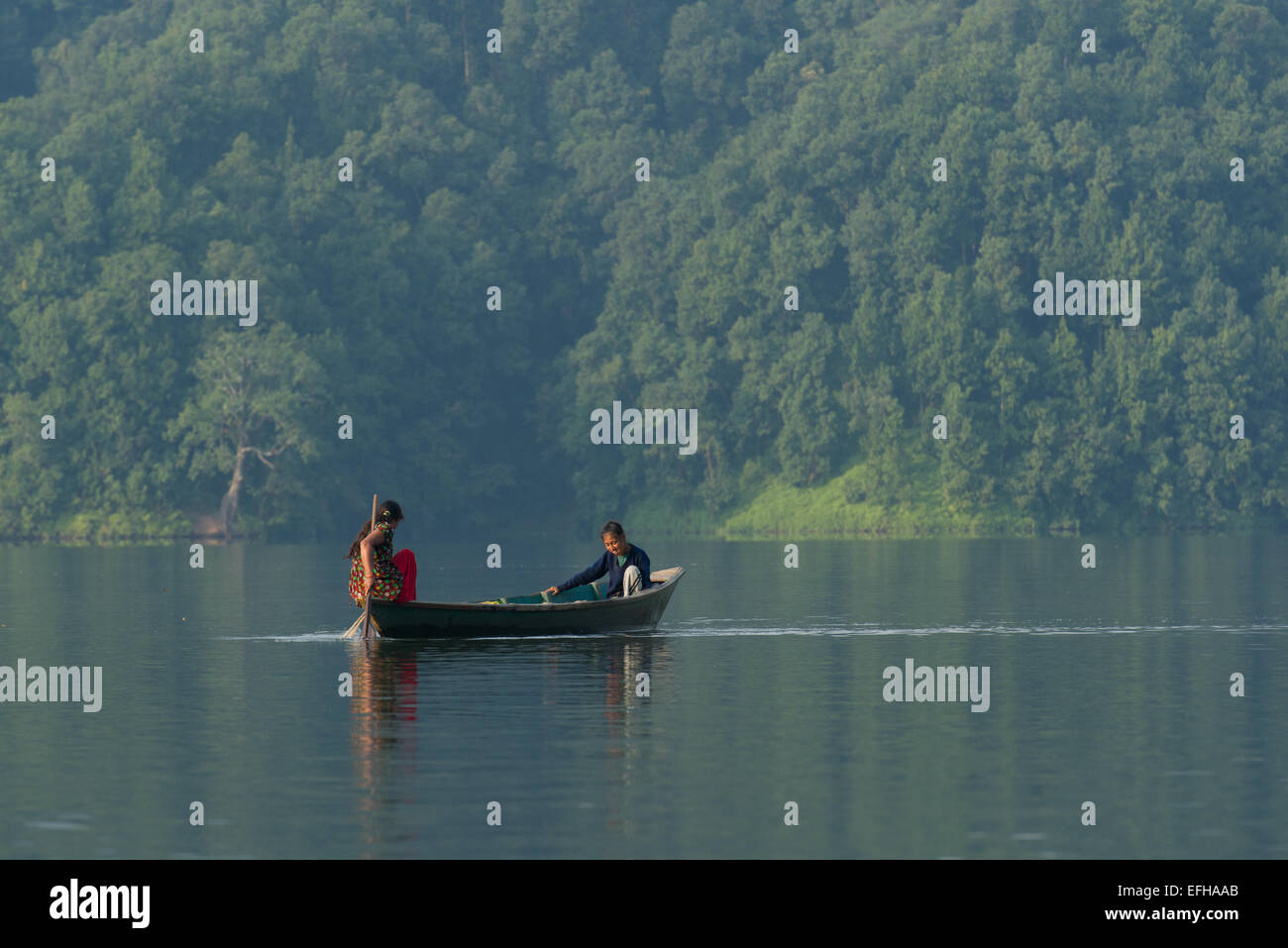 Locals fishing from a small boat on begnas lake hi-res stock ...