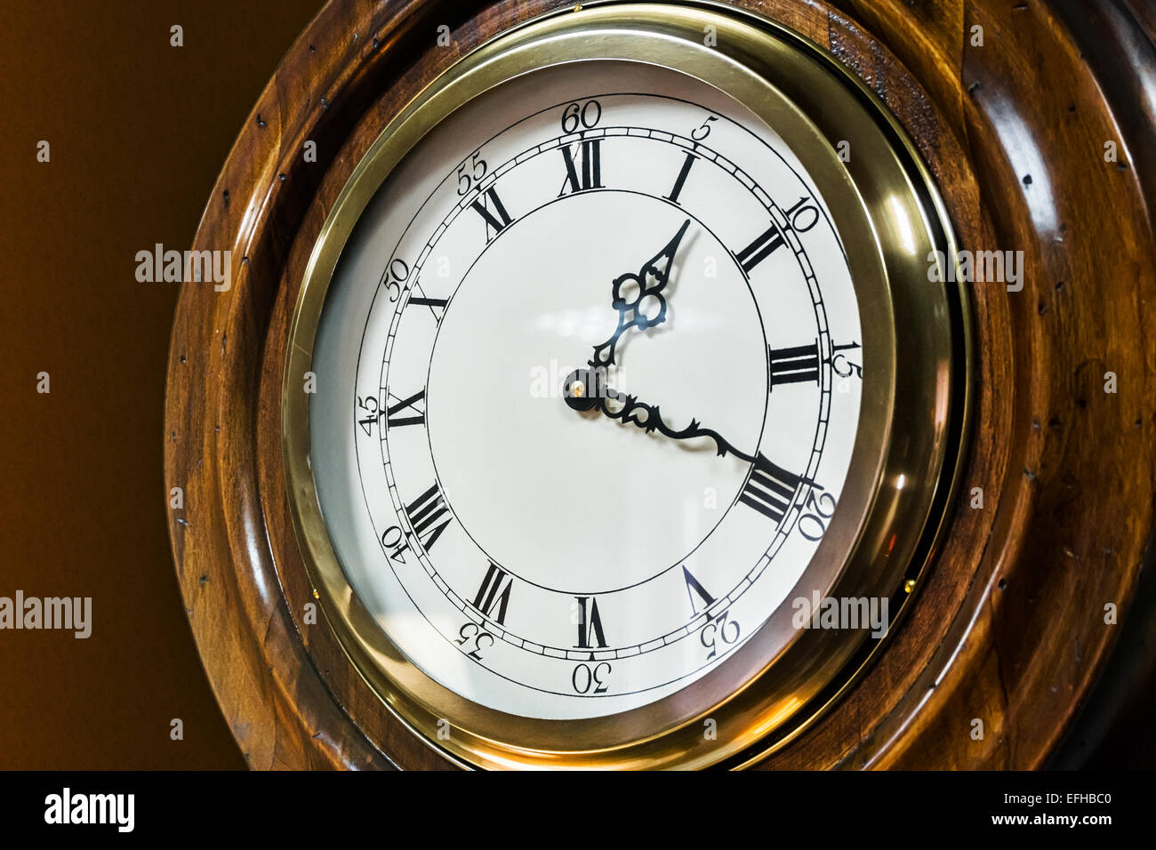 Classic vintage clock with moving pointer on brown wall Stock Photo - Alamy