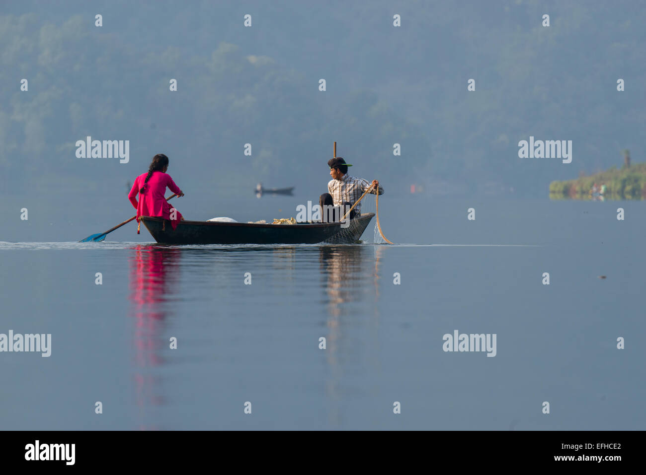 Locals fishing from a small boat on begnas lake hi-res stock ...