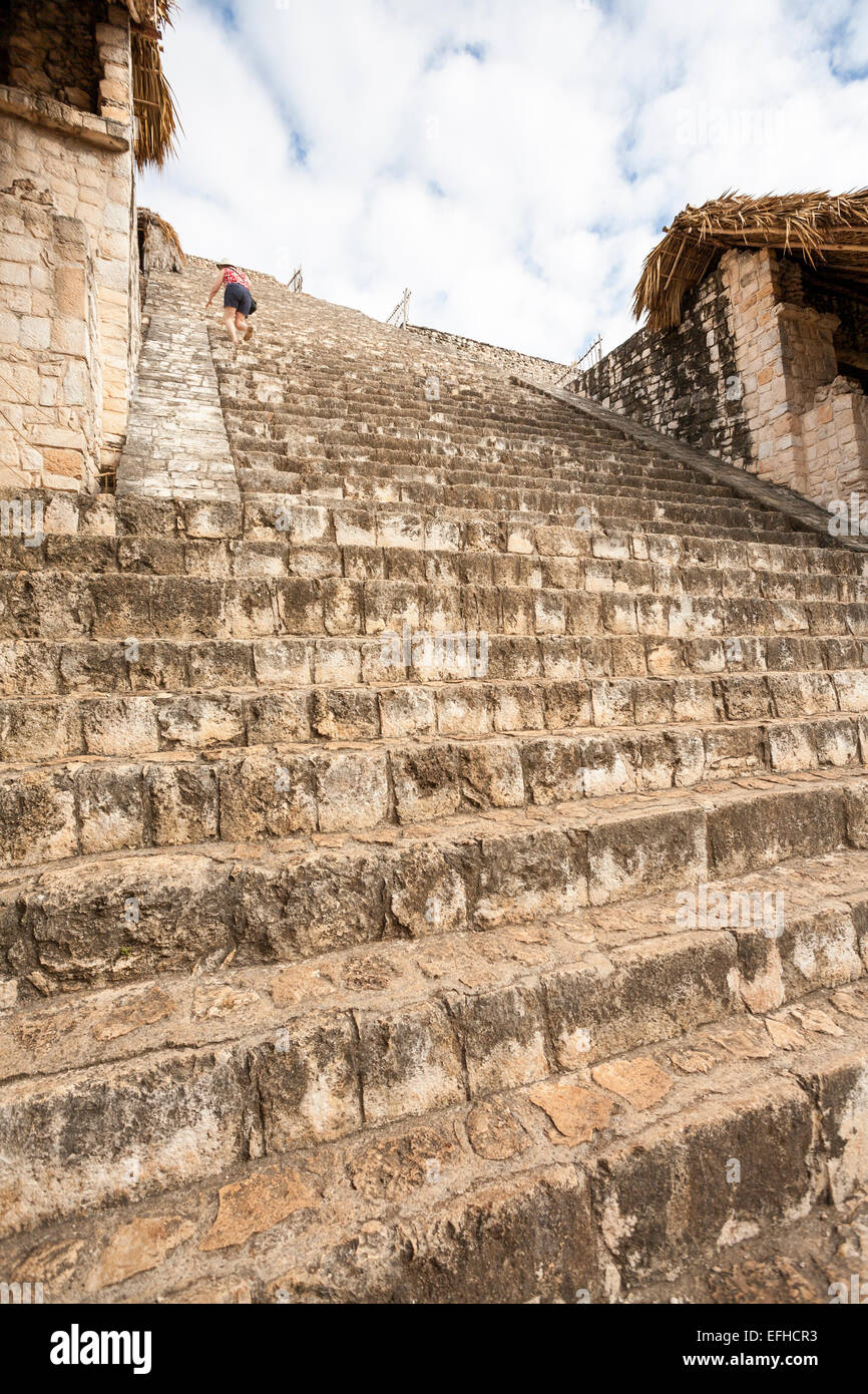 A tourist climbs the stairs to the Acropolis at Ek' Balam. This long ...