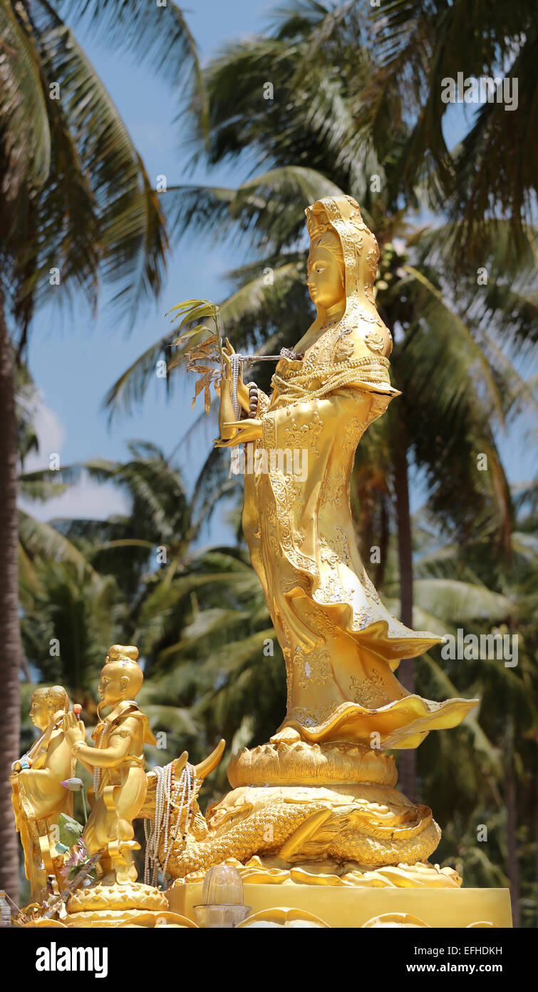 beautiful statue Guan Yin Chinese Goddess of Mercy in the palm grove ...