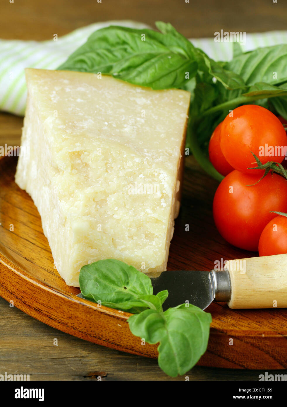 fresh tasty hard parmesan cheese on a wooden board Stock Photo - Alamy