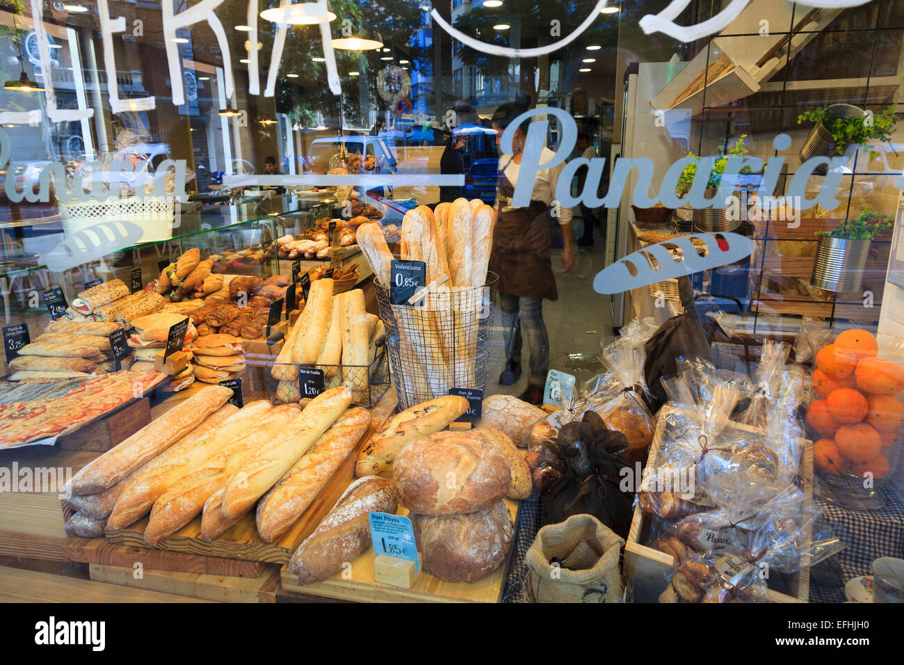 Looking through the window of a Spanish bread and pastry shop with ...
