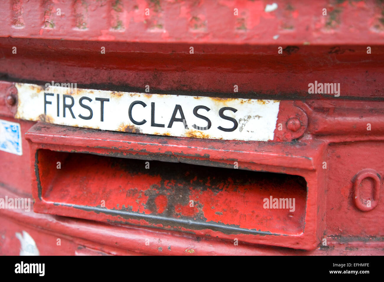 British first class mail box slot in old traditional red pillar box ...