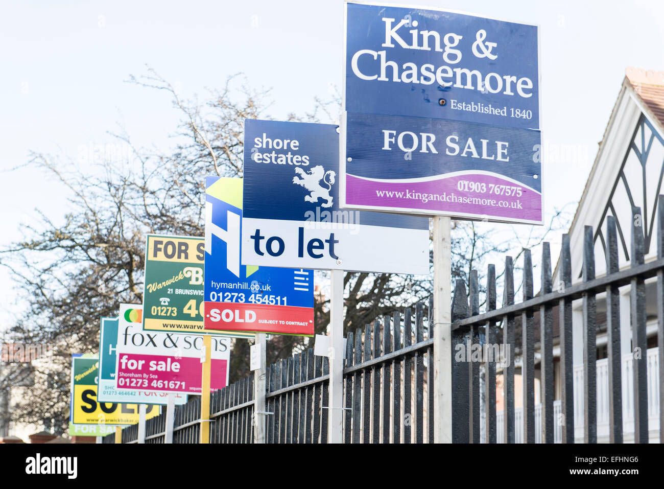 lots of estate agent boards for sale, sold, to let boards all lined up ...