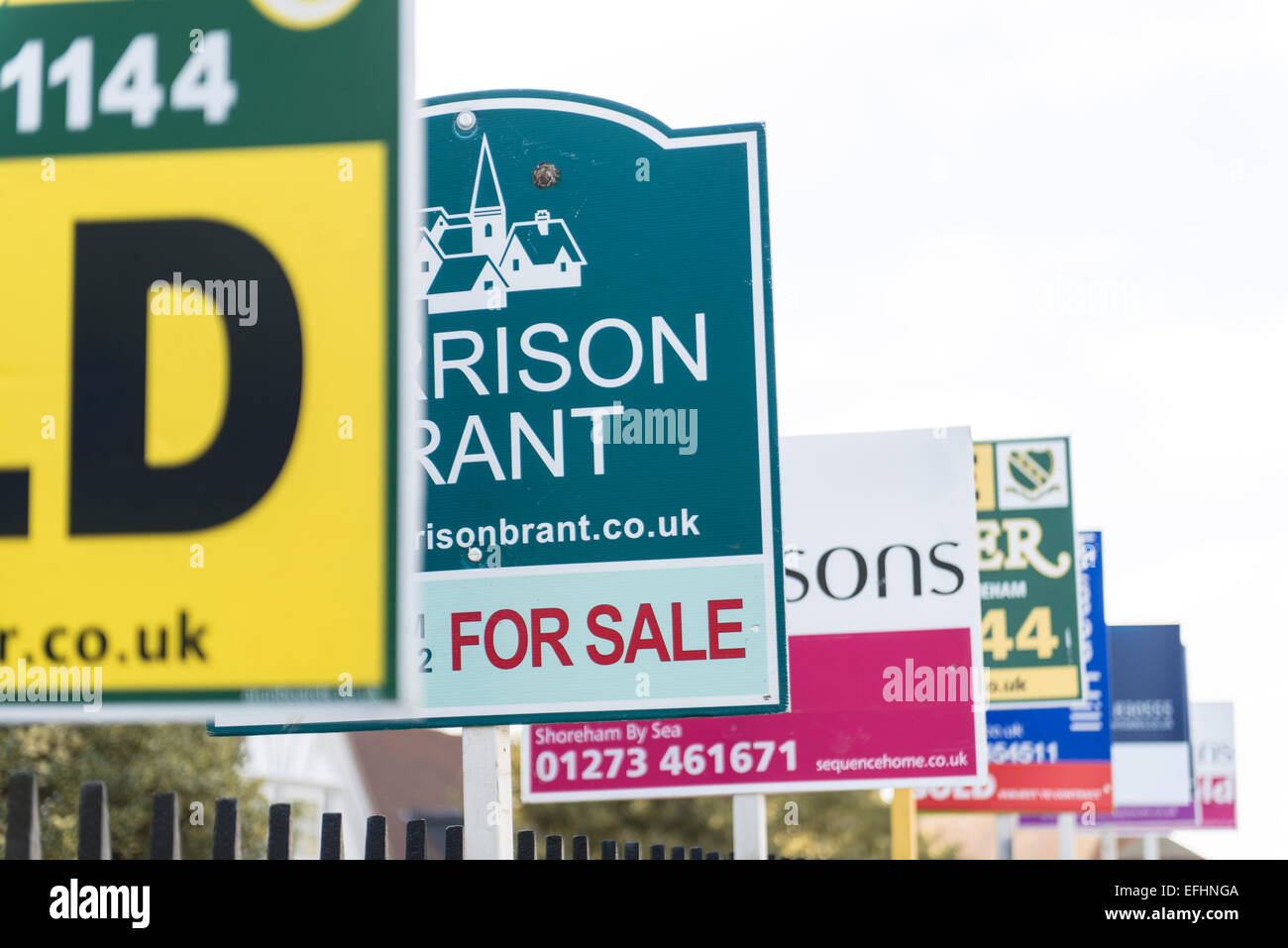 lots of estate agent boards for sale, sold, to let boards all lined up ...