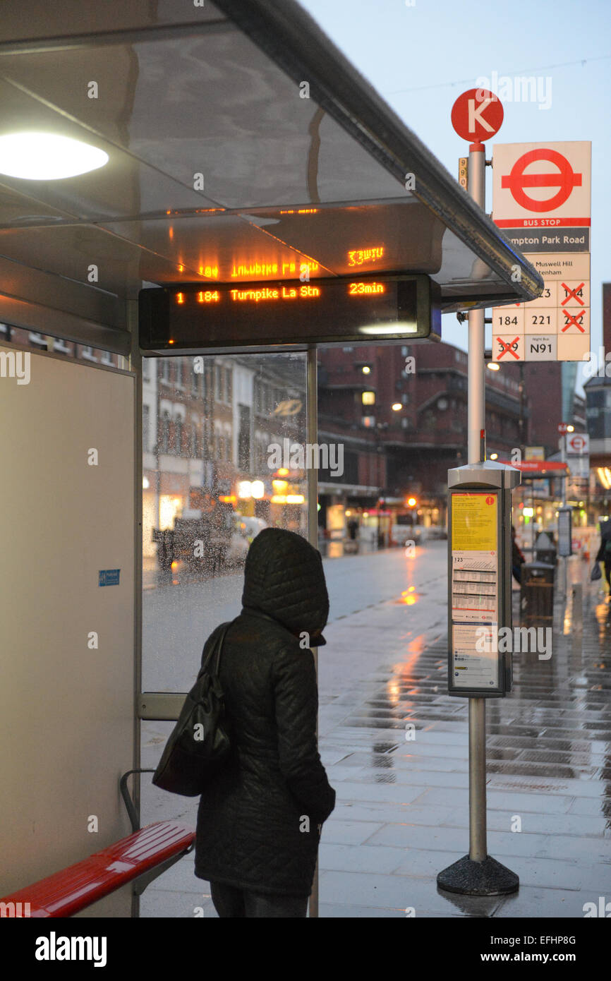Turnpike Lane, London, UK. 5th February 2015. A woman at a bus stop ...