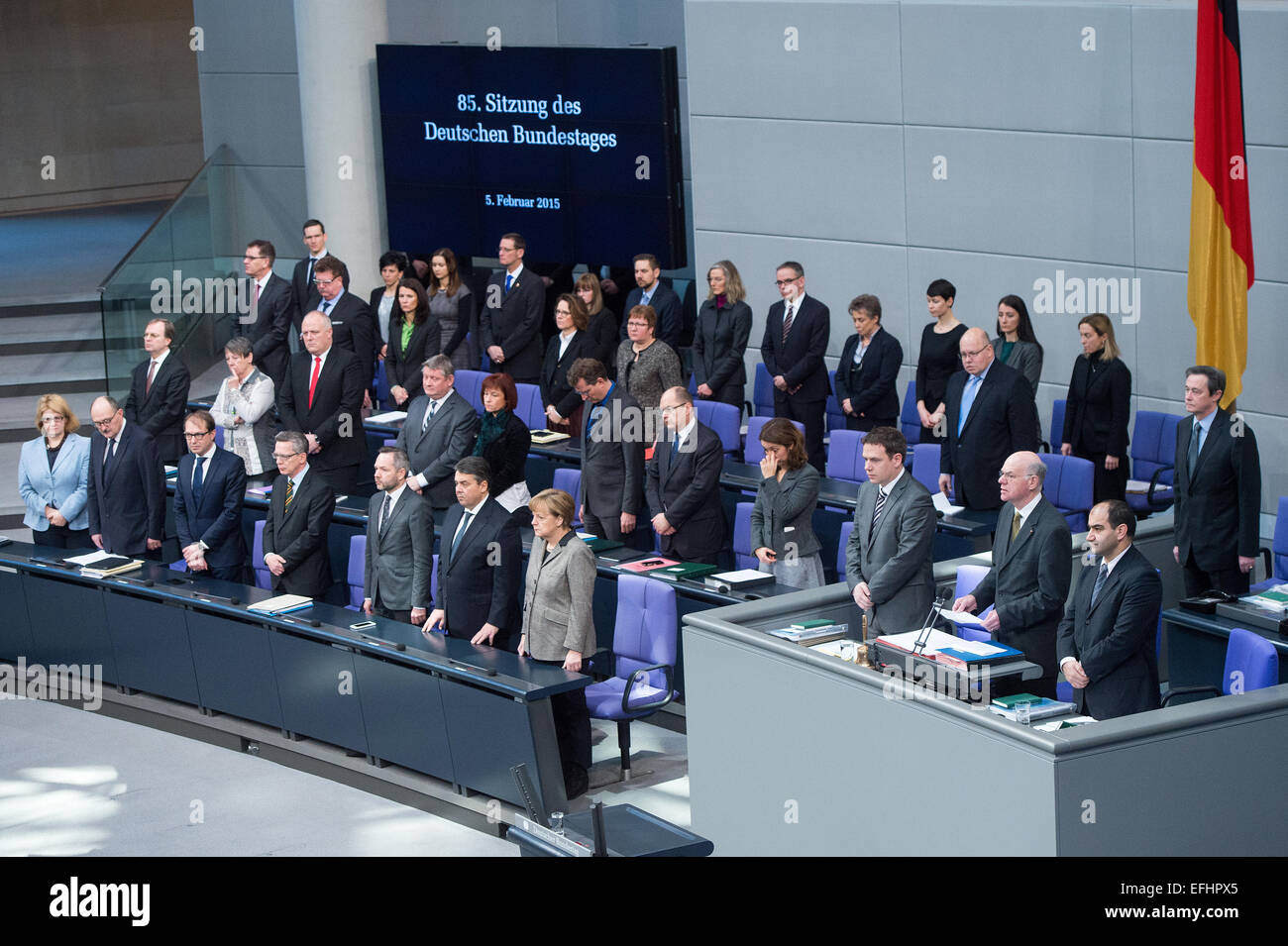 Members of the German government stand in remembrence of the recently ...
