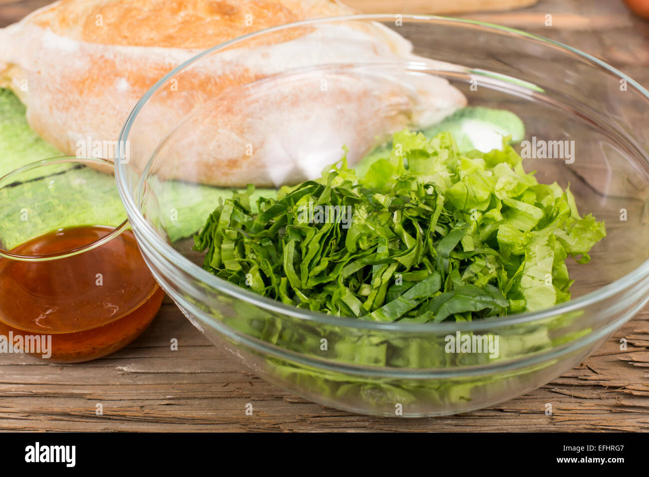 chopped lettuce in a glass bowl on the old wooden table Stock Photo - Alamy
