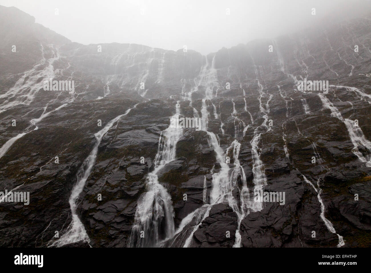 Waterfalls running down a rock face after rain, Milford Sound, South ...