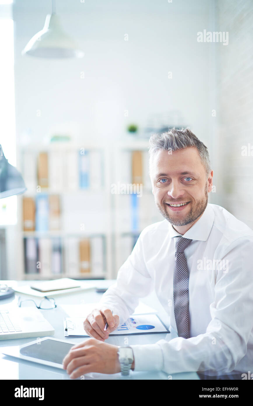 Cheerful manager working in office Stock Photo - Alamy