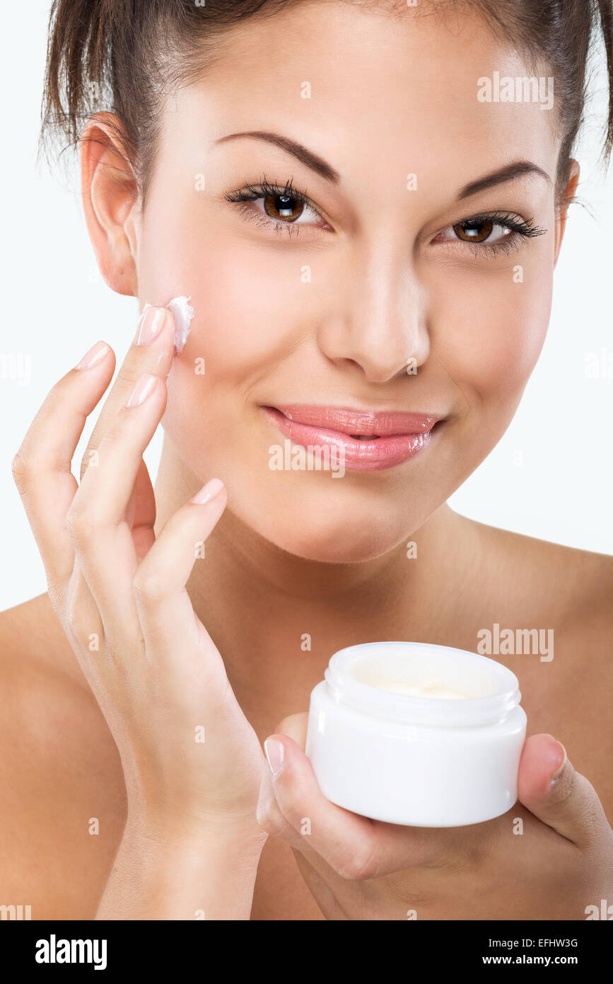 Flawless-skinned woman with moisturizing face cream Stock Photo - Alamy