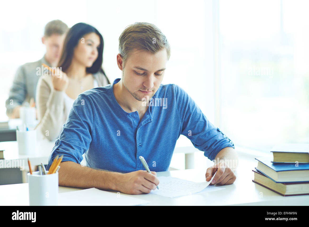 Adult male writing test hi-res stock photography and images - Alamy