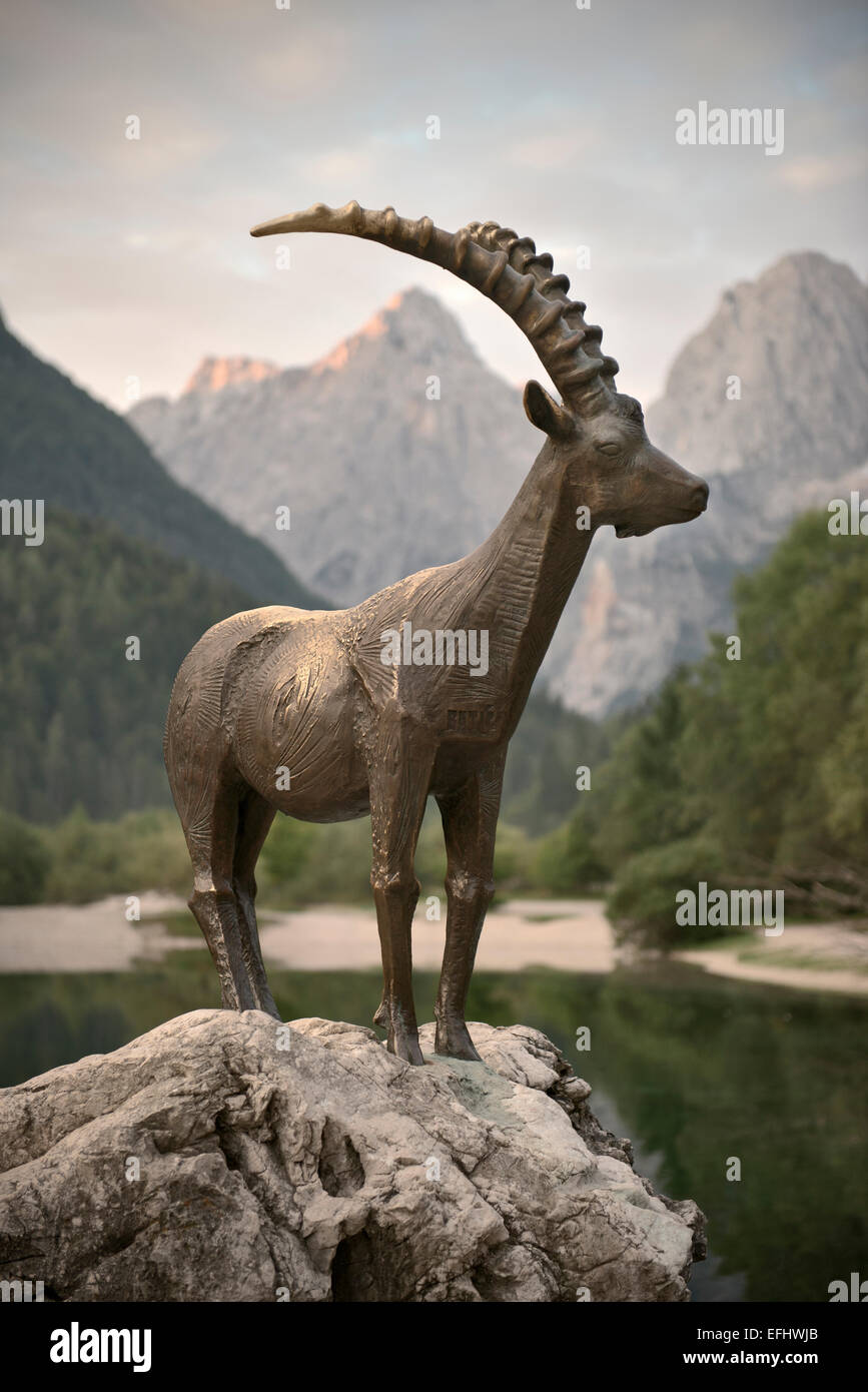 Capricorn Zlatorog at Jasna Lake with mountains in backdrop, Kranjska ...