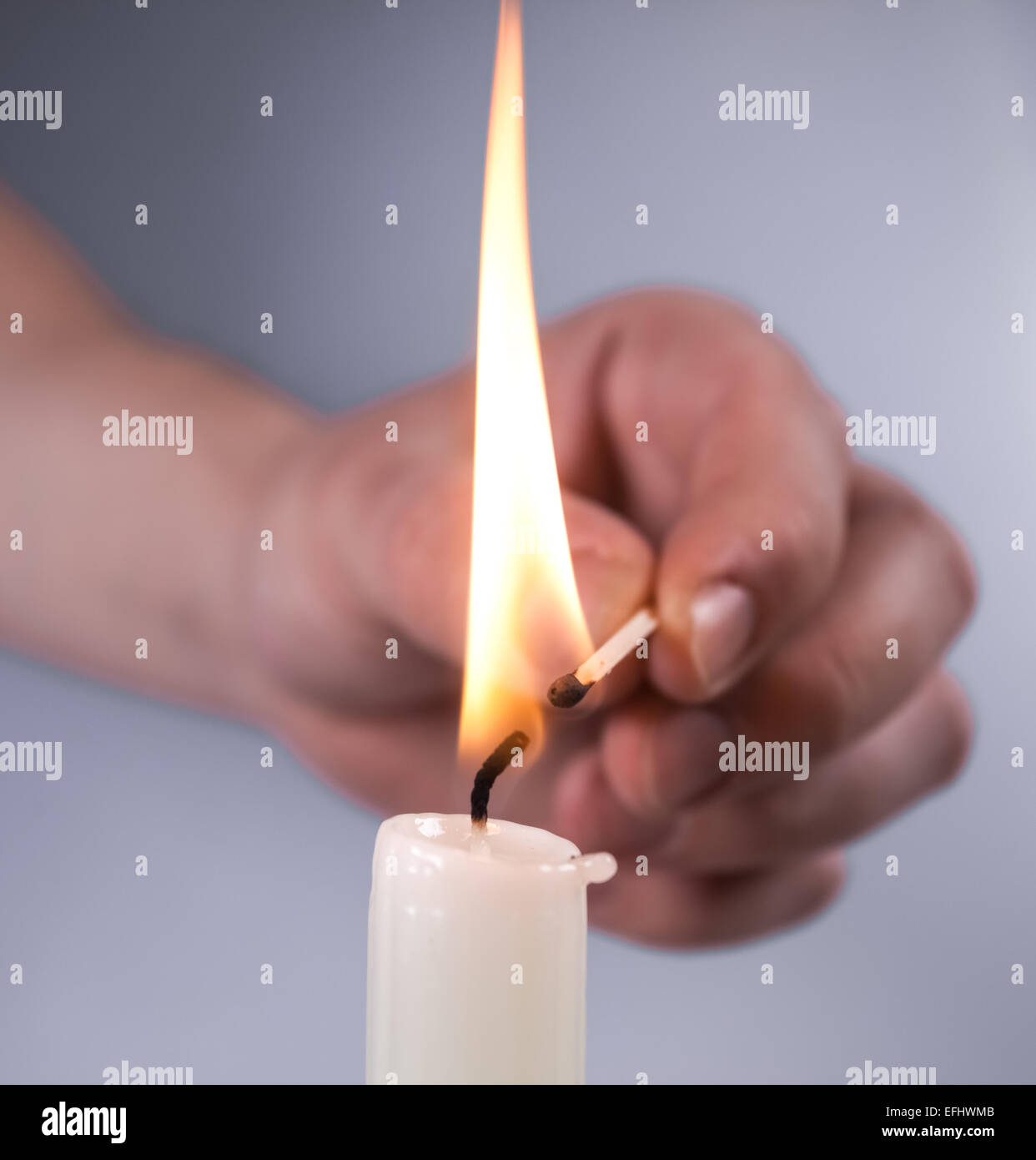 Hand holding lit match igniting hi-res stock photography and images - Alamy