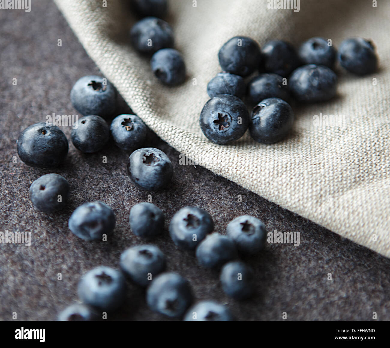 Blueberries, grey felt and linen as background Stock Photo - Alamy