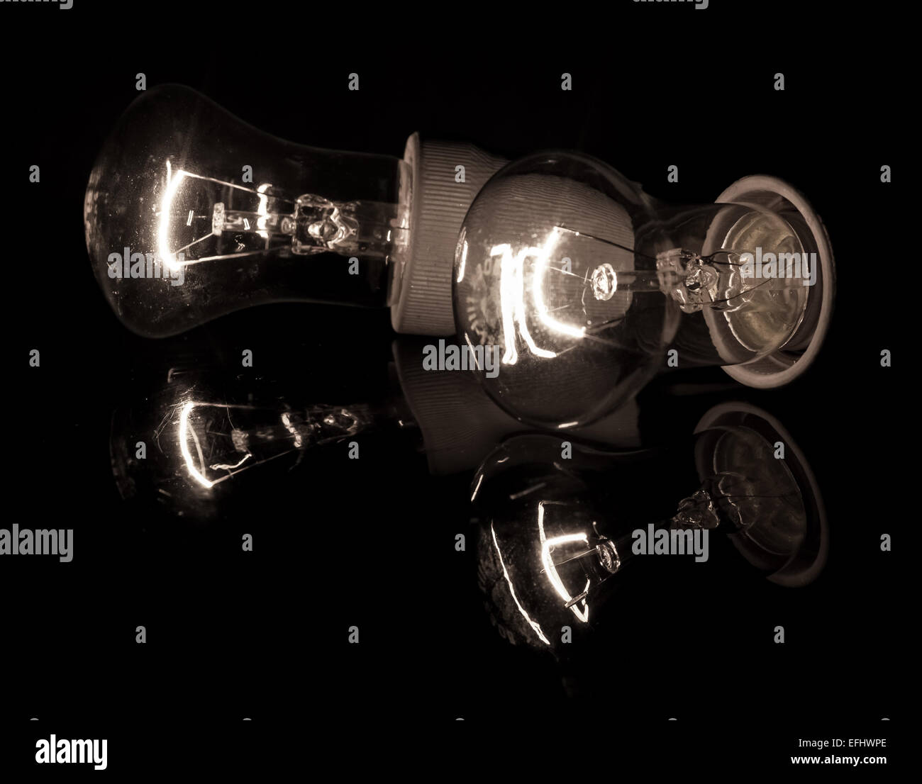 ordinary lighted lamp on a dark background Stock Photo - Alamy