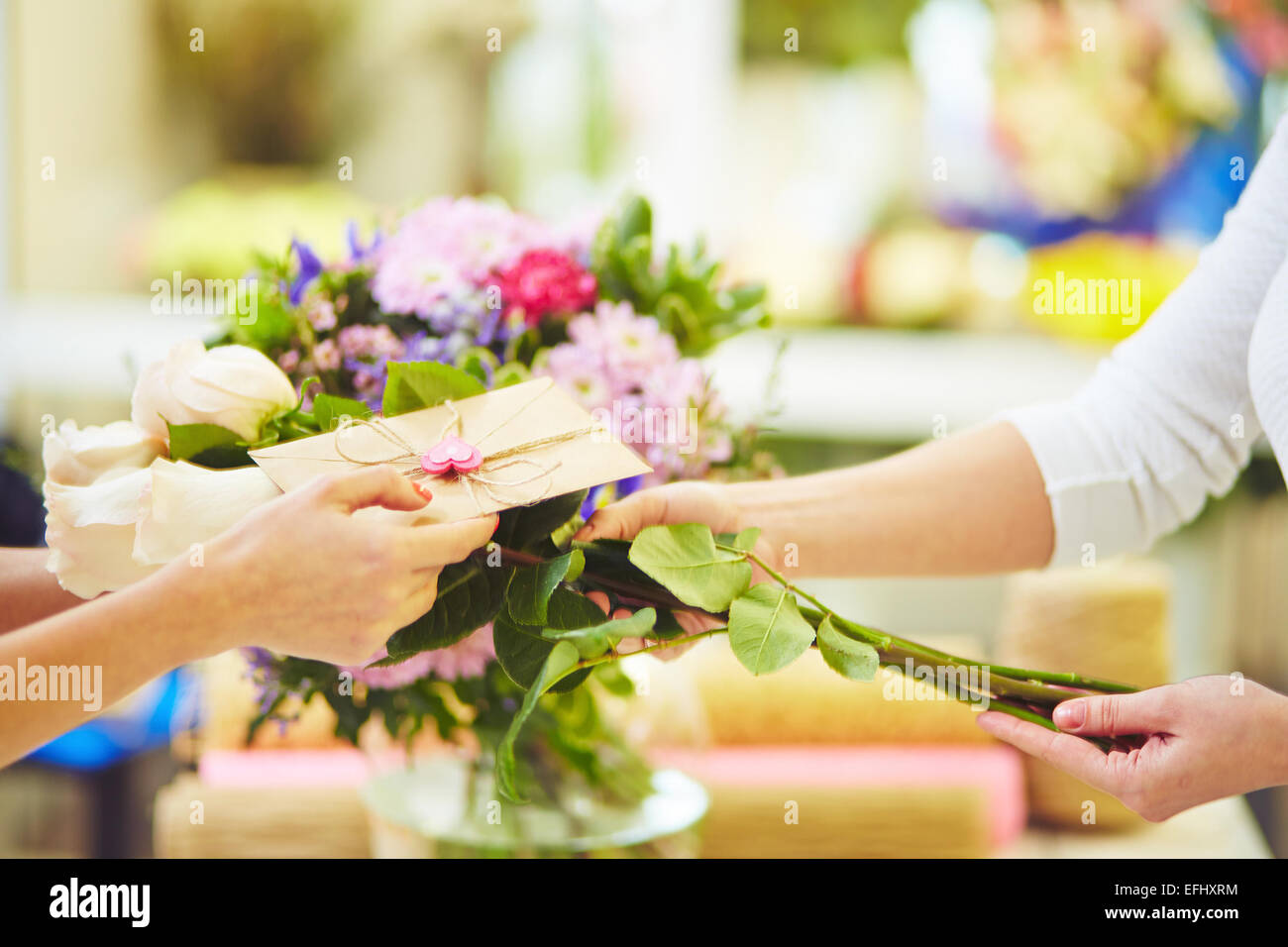Female florist selling bunch of white roses Stock Photo - Alamy
