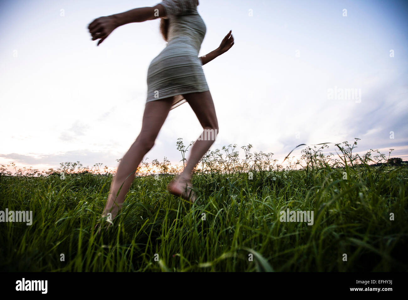 Young woman running over a meadow, Upper Bavaria, Germany Stock Photo ...