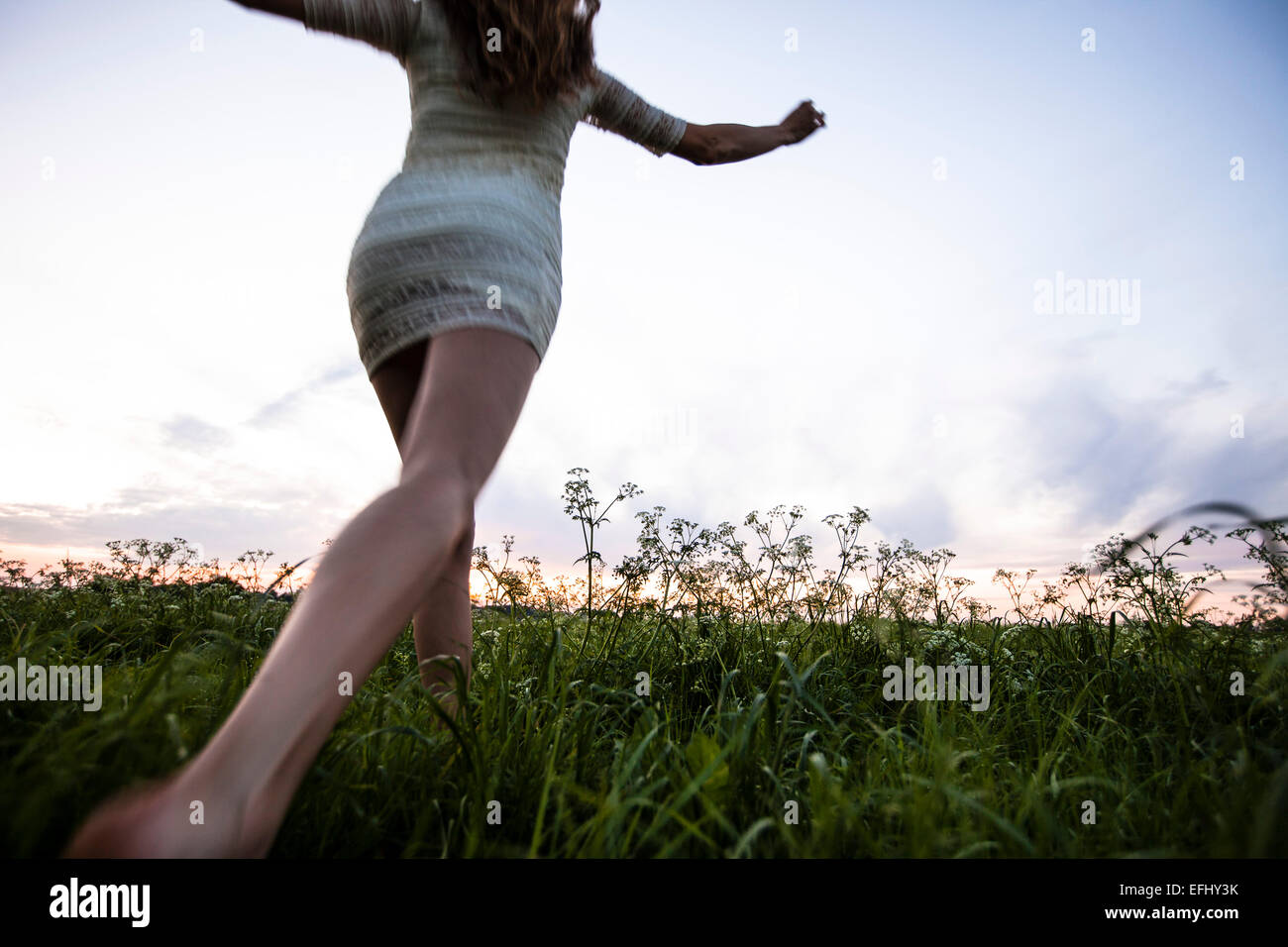 Young woman running over a meadow, Upper Bavaria, Germany Stock Photo ...