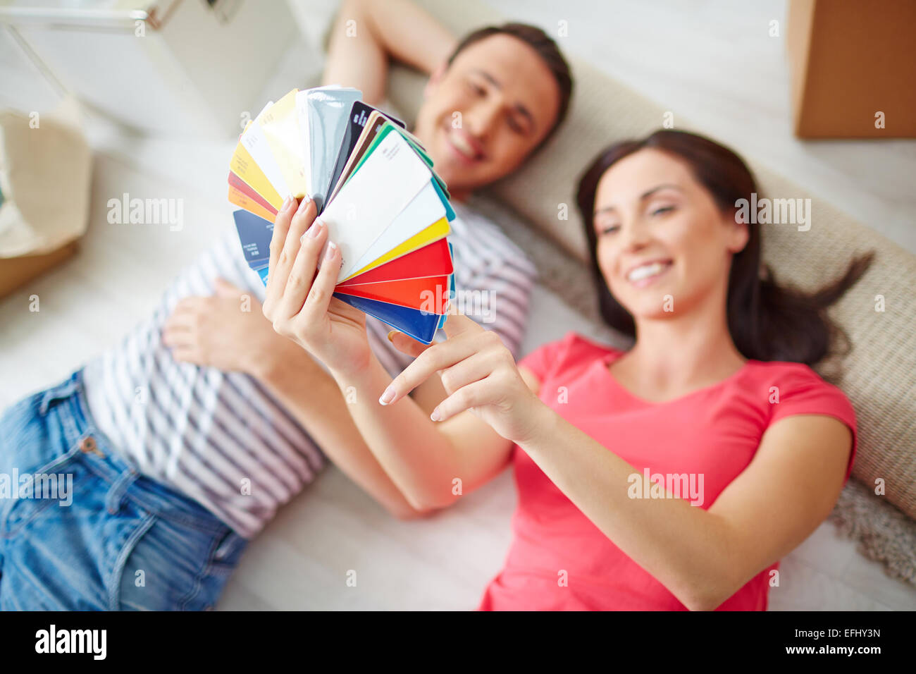 Happy young couple choosing color from palette Stock Photo - Alamy