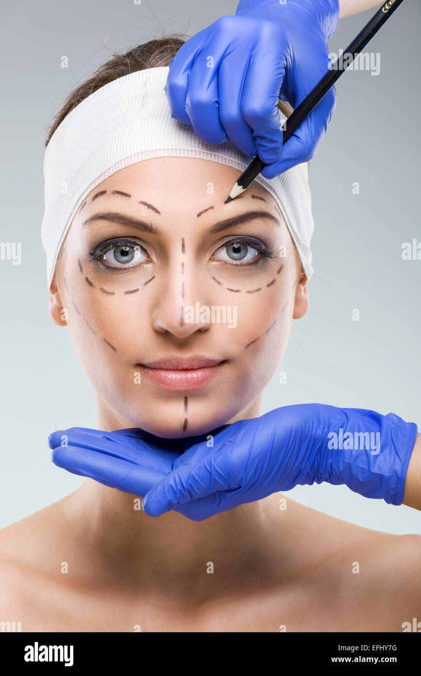 Beautiful woman with plastic surgery, depiction, plastic surgeon hands ...