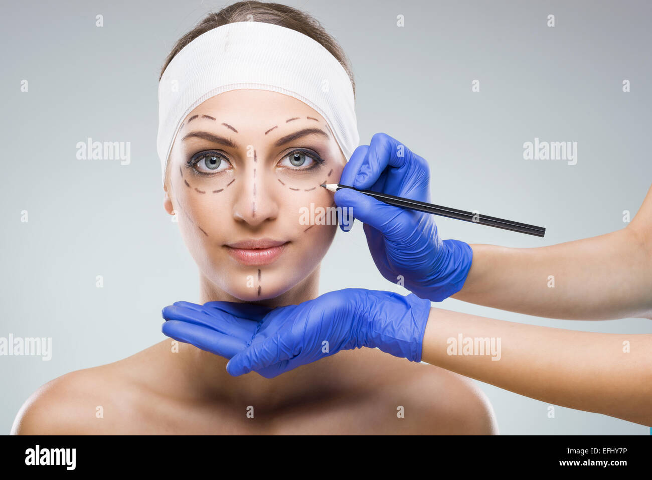 Beautiful woman with plastic surgery, depiction, plastic surgeon hands ...