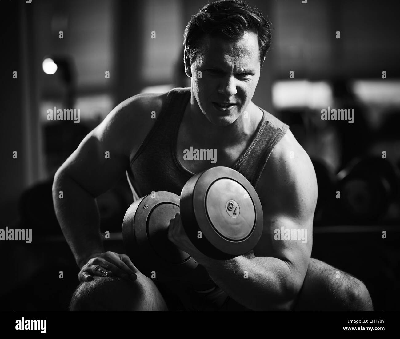 Young man doing exercise with barbell in gym Stock Photo - Alamy