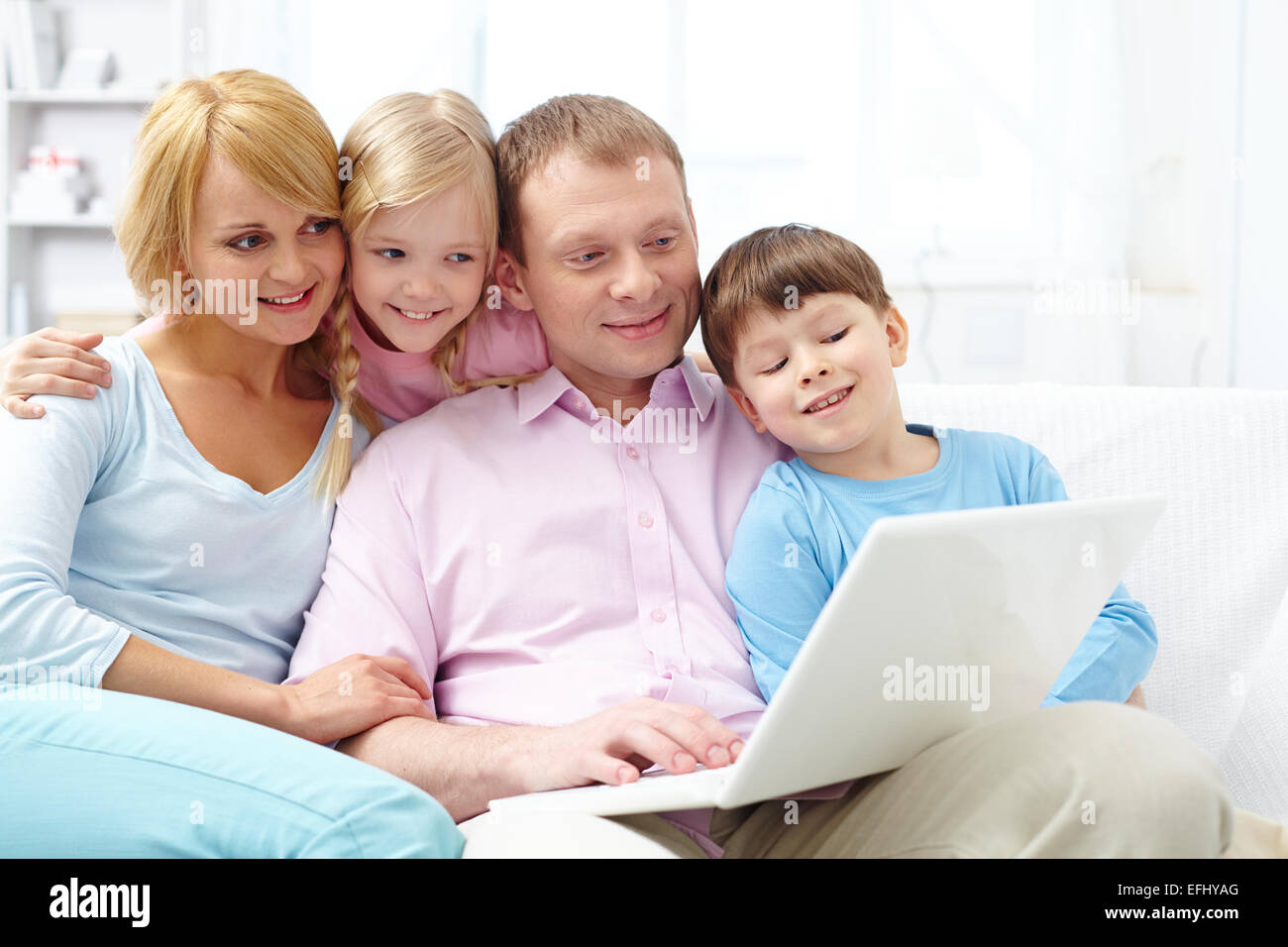 Modern family networking with laptop at home Stock Photo - Alamy
