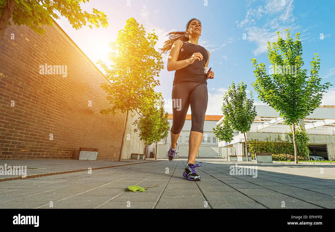 Pretty female runner in the outdoors Stock Photo - Alamy