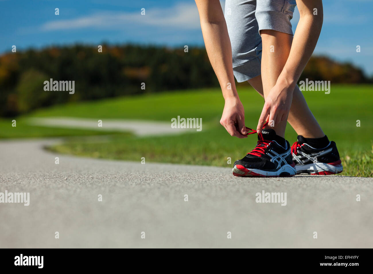 Woman lacing shoes, Munsing, Bavaria, Germany Stock Photo - Alamy