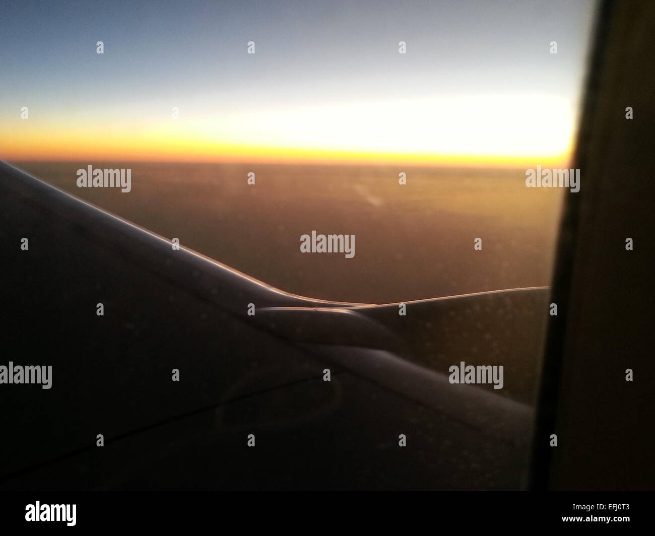 Sunset from a airplane window Stock Photo - Alamy