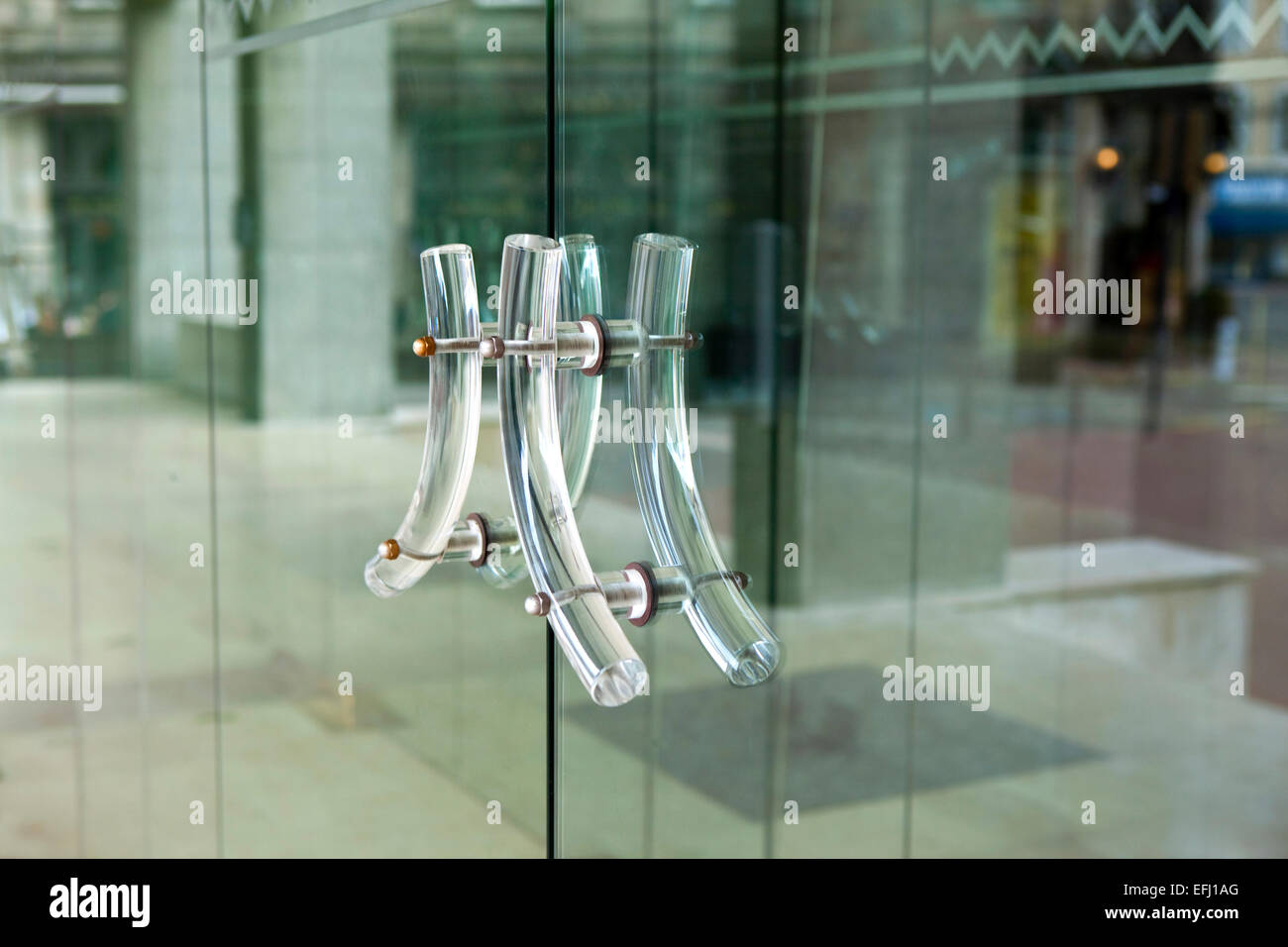 Stylish handles of a glass door Stock Photo - Alamy