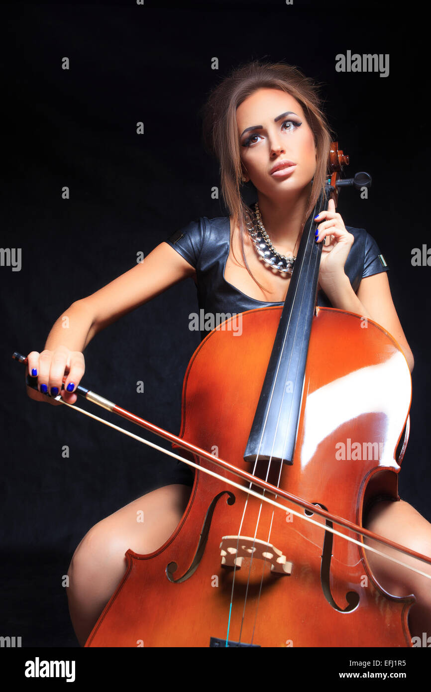 beautiful female musician playing a cello Stock Photo - Alamy