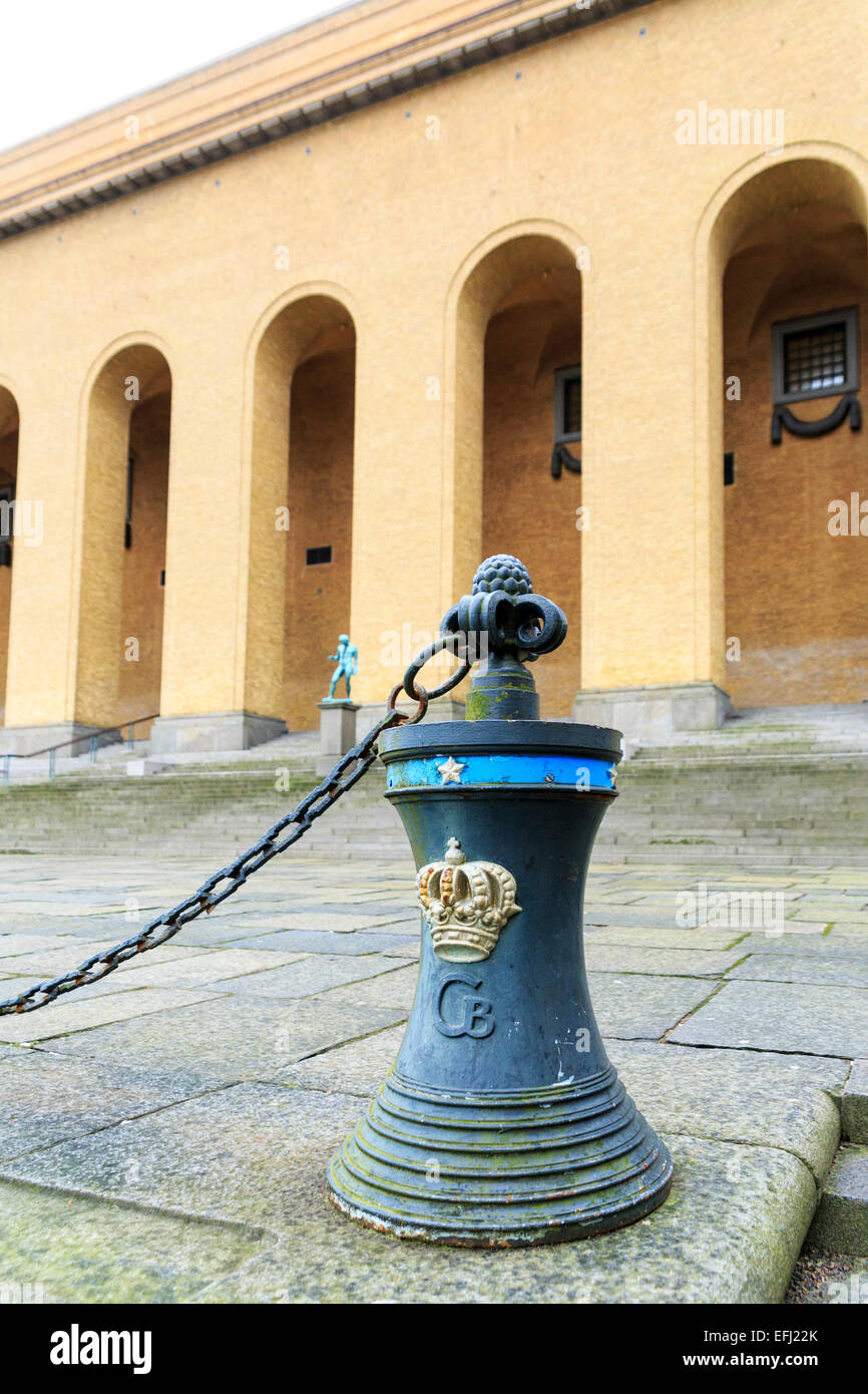Close up view of ornate chain link cast iron bollard with golden crown ...