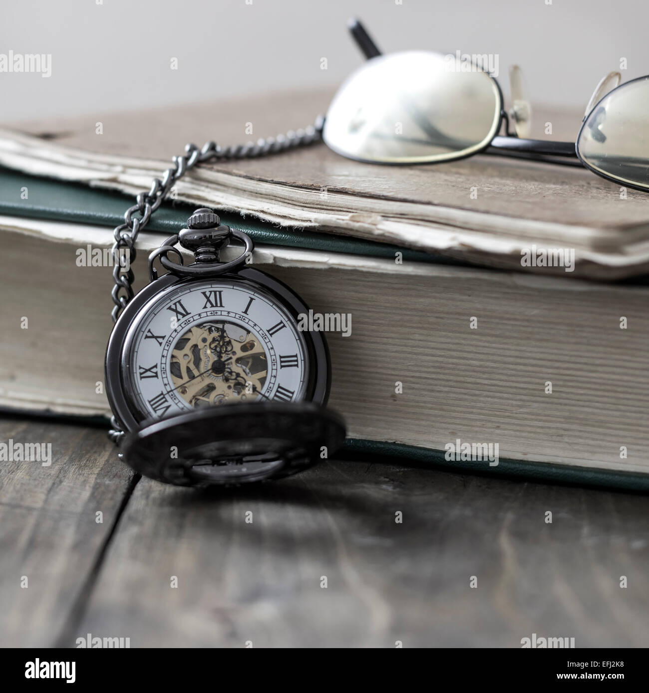 An antique pocket watch, glasses and bible in close up Stock Photo - Alamy