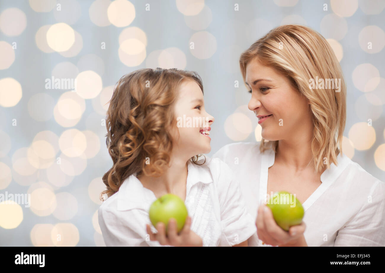 happy mother and daughter with green apples Stock Photo - Alamy