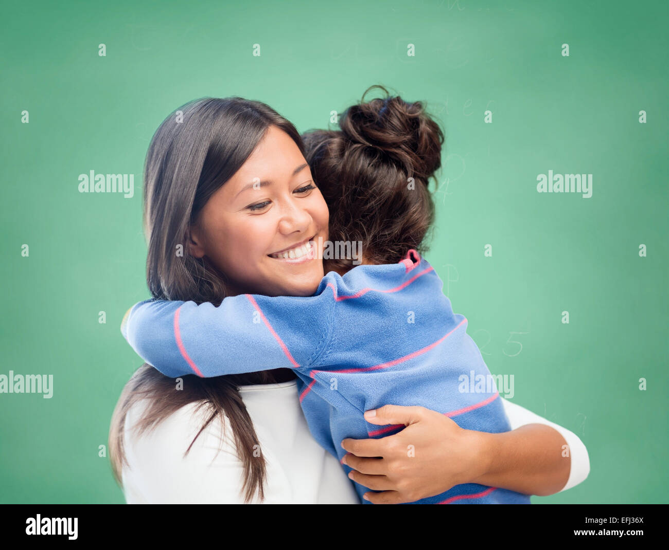 happy woman and little girl hugging at school Stock Photo - Alamy