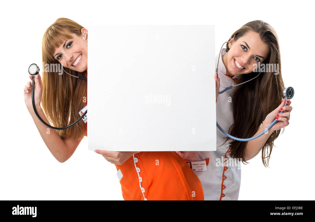 Two nurses. Look behind blank board with stethoscope Stock Photo - Alamy