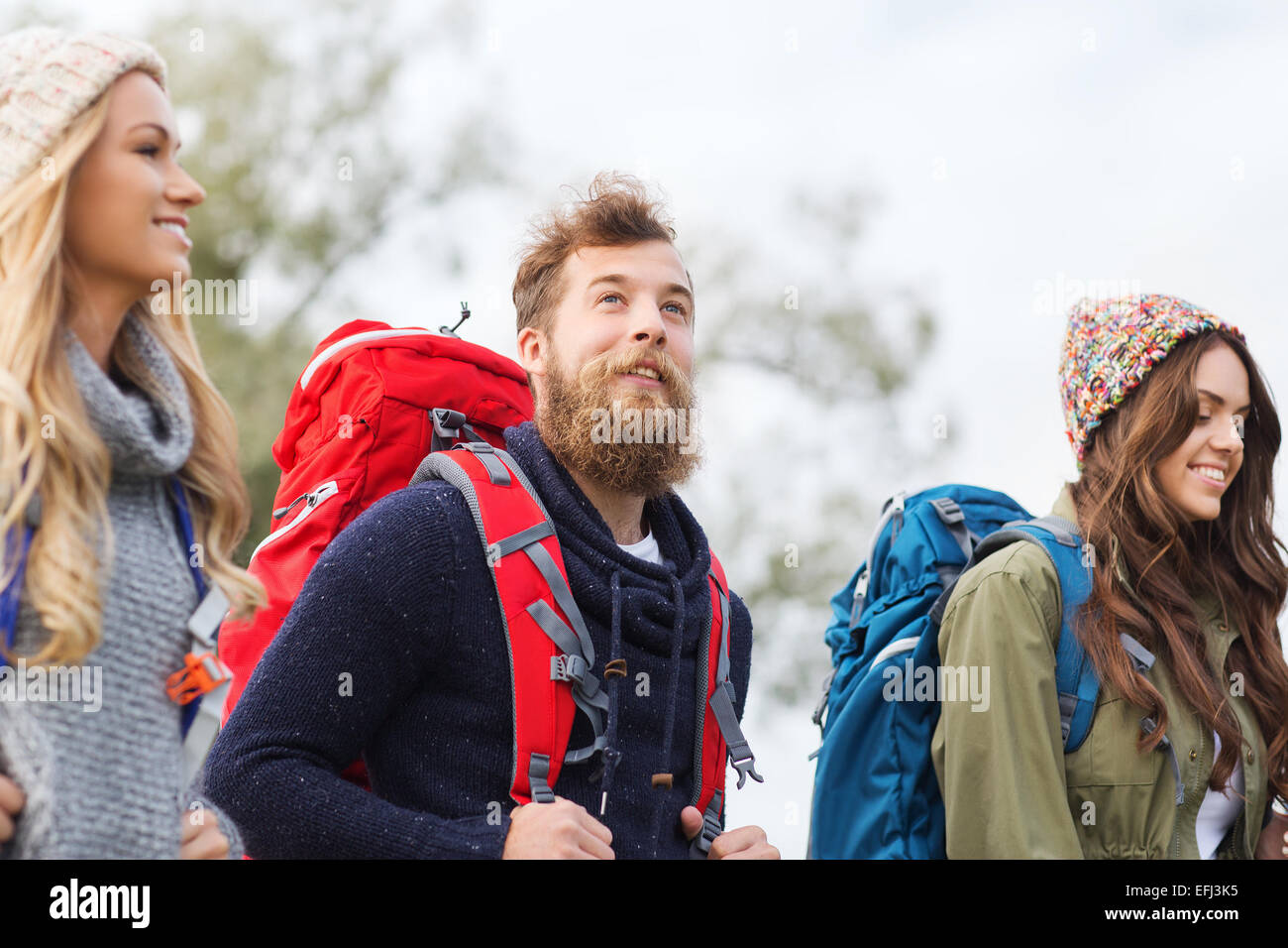 group of smiling friends with backpacks hiking Stock Photo - Alamy