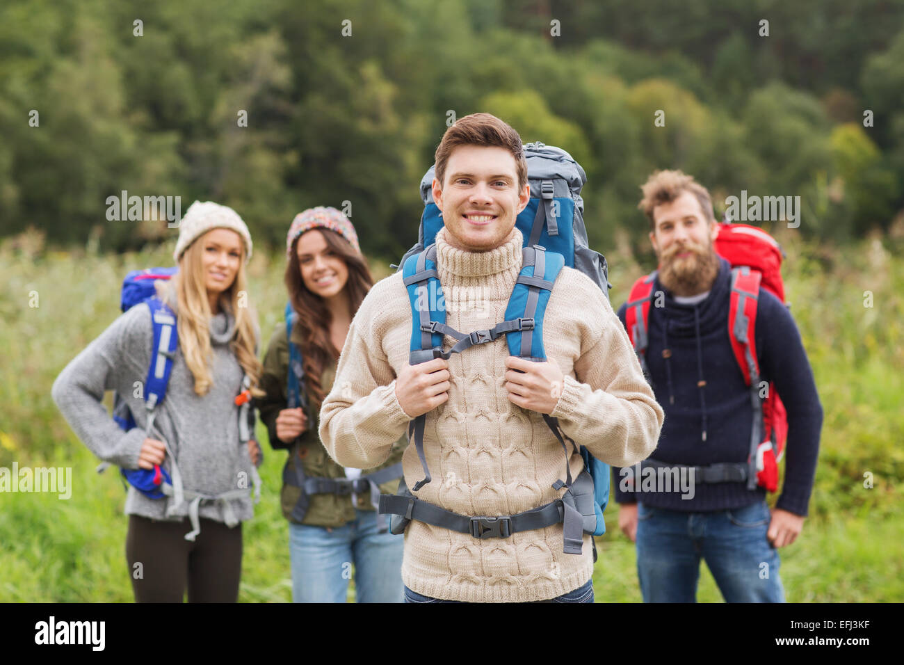 group of smiling friends with backpacks hiking Stock Photo - Alamy