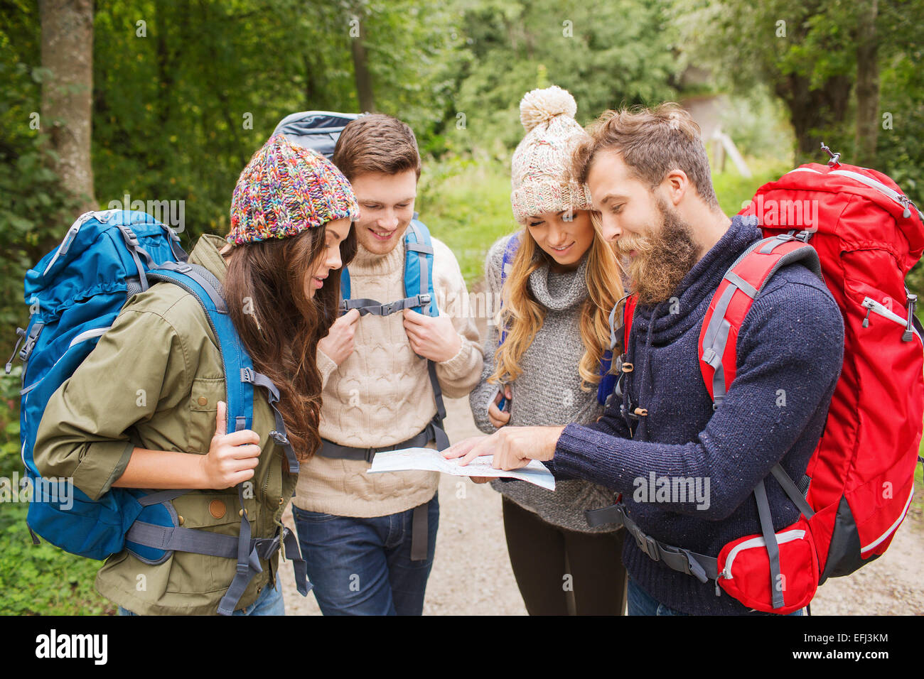 group of smiling friends with backpacks hiking Stock Photo - Alamy